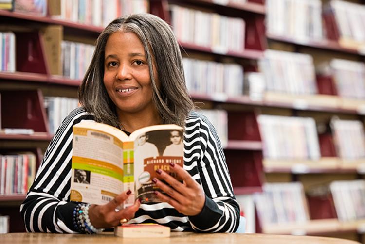 Rhonda Crowder sitting at a table with a book.